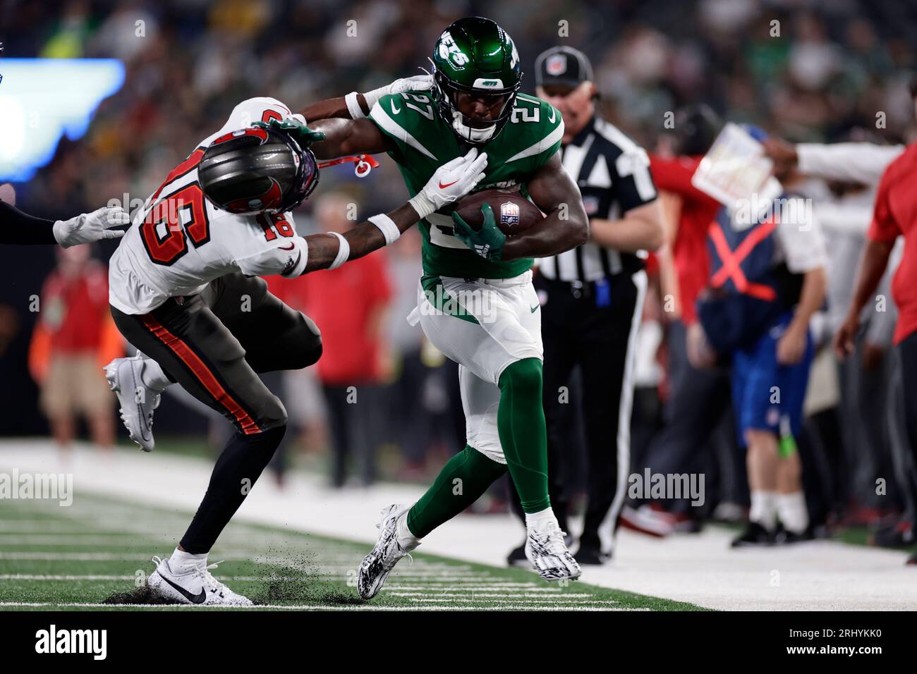 New York Jets running back Zonovan Knight (27) stiff-arms Tampa Bay ...
