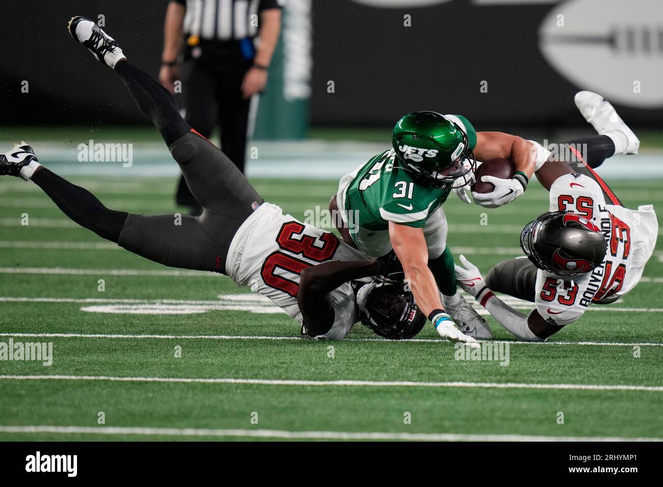 New York Jets' Jerome Kapp (31) is tackled by Tampa Bay Buccaneers' Dee Delaney (30) and Brandon ...