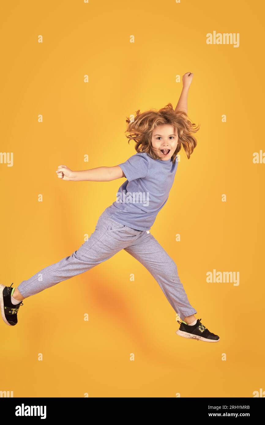Funny boy jumping. Little child jumping over a yellow background Stock ...