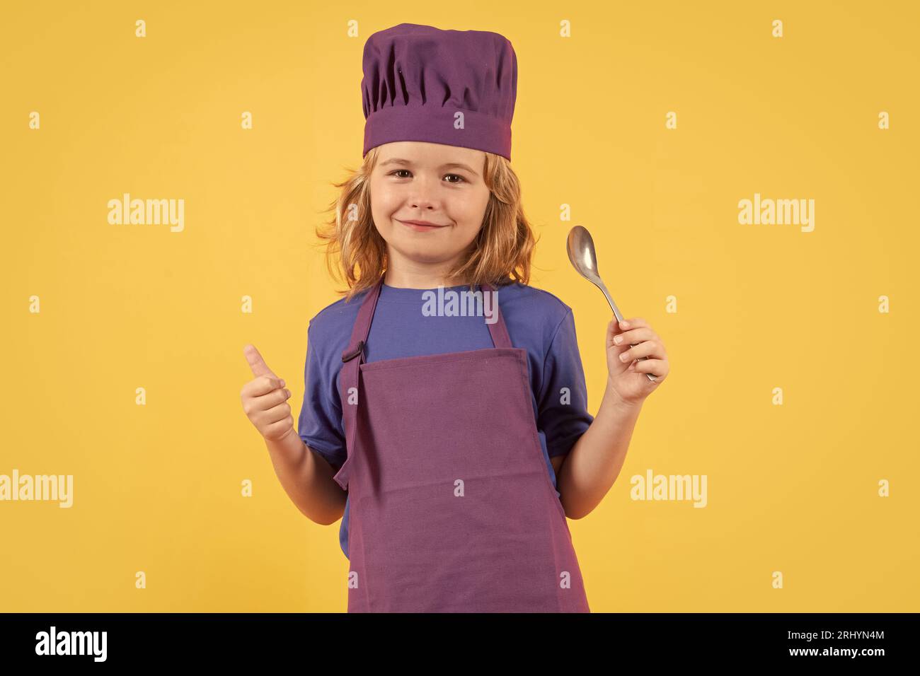 Funny kid chef cook with spoon, studio portrait. Kid in cooker uniform ...