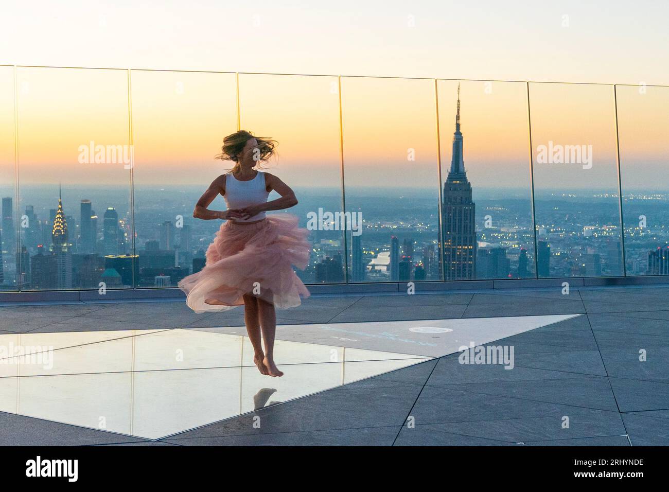 Influencer Laura Giromini jumps into a dance pose as sun rises above ...