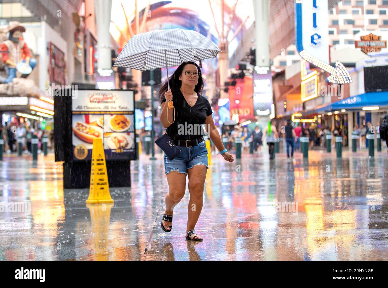 A woman runs through the rain on Fremont Street in downtown Las Vegas ...