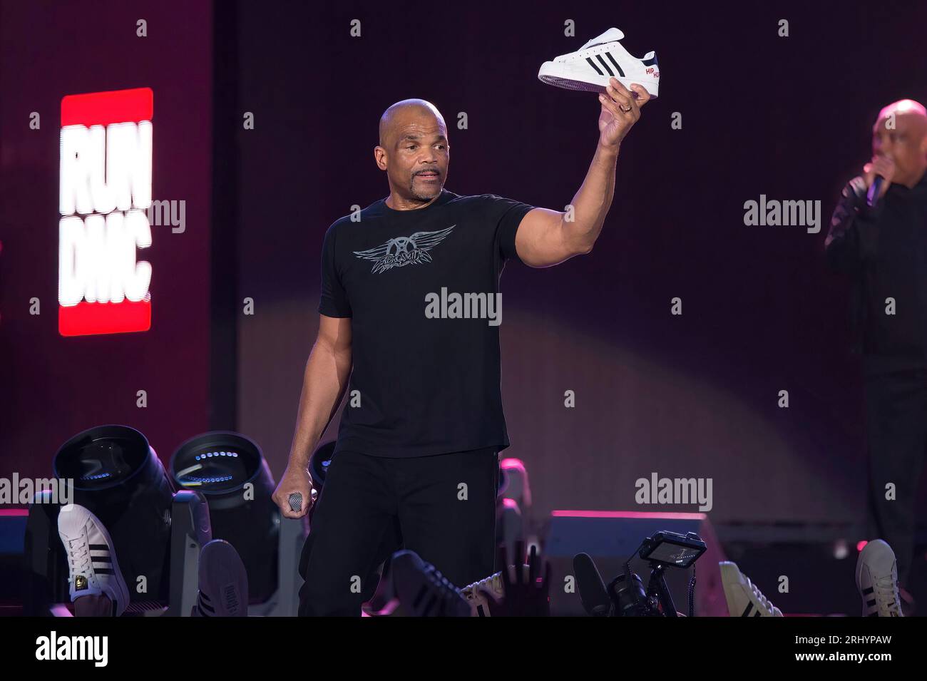 Rapper Darryl McDaniels of Run DMC holds a sneaker from Adidas while ...