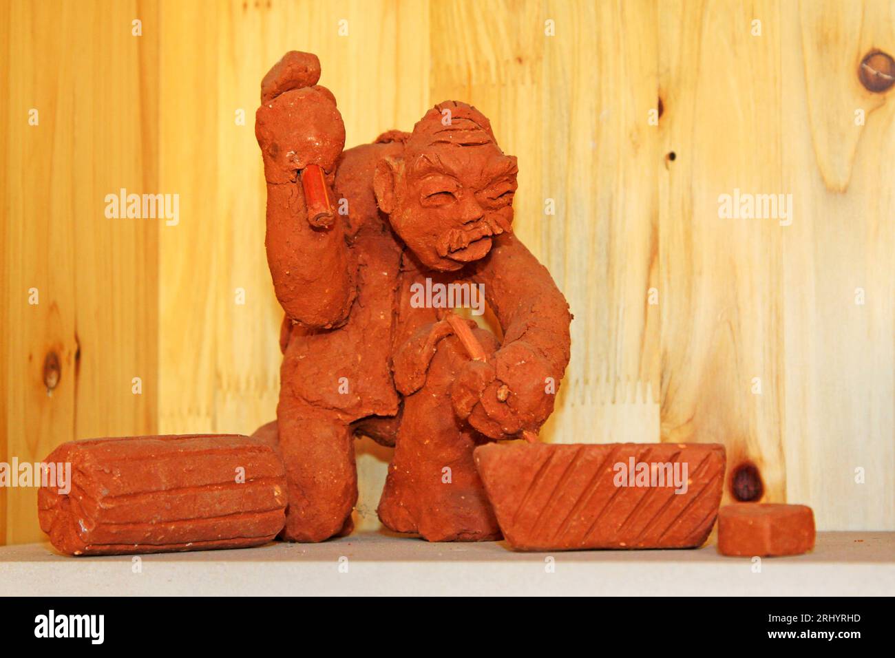 Clay figurine works by hand in a shop Stock Photo - Alamy
