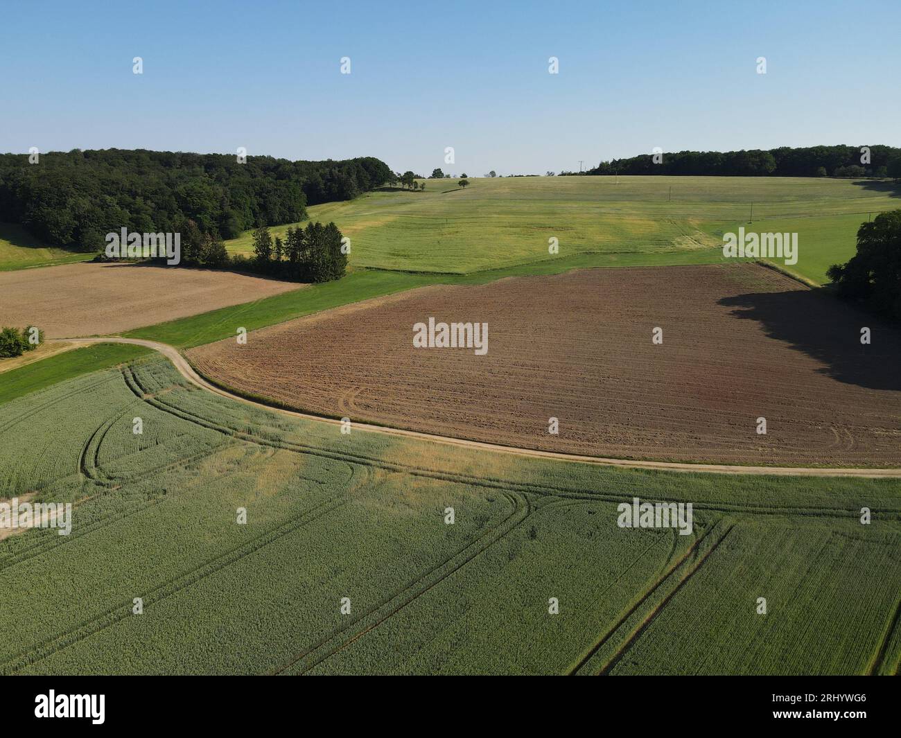 Agriculture land with green crop fields, brown plowed dirt fields ...