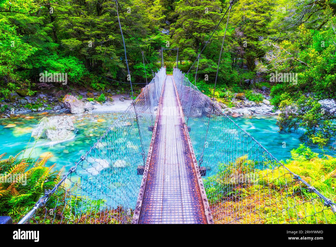 Hanging bridge across pristine fresh stream of mountain river on Lake ...