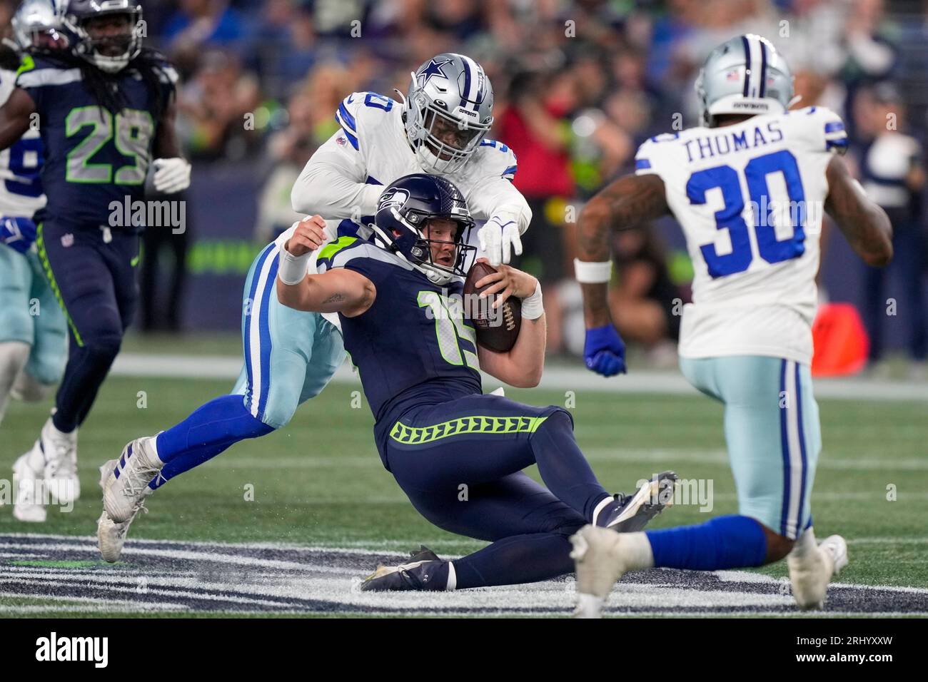 Seattle Seahawks quarterback Holton Ahlers is tackled by Dallas Cowboys ...