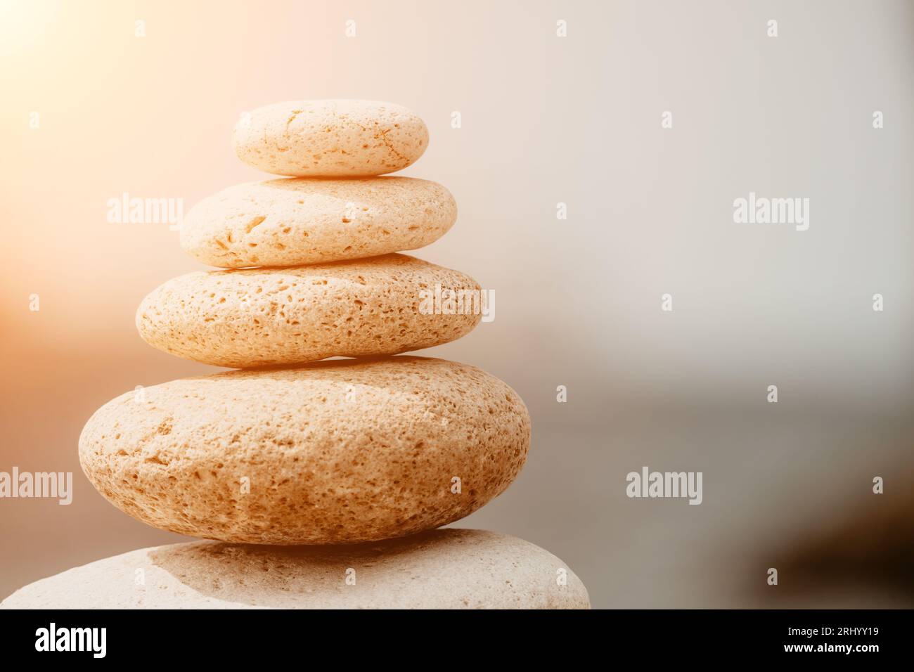 balanced rock pyramid on the pebbled beach is a study in harmony and ...