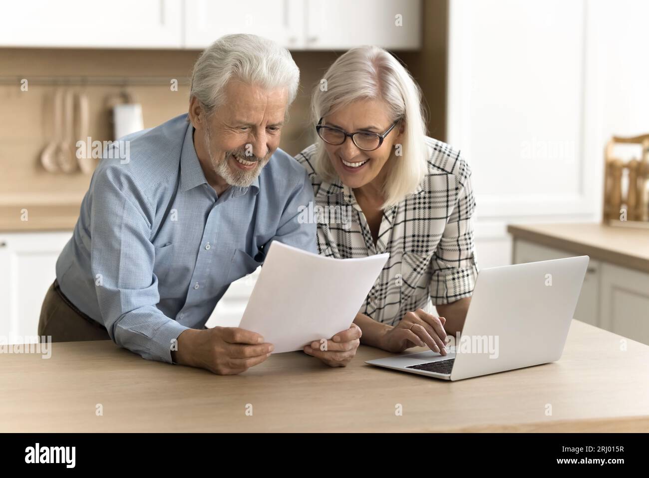 Happy satisfied senior retired couple reading legal document Stock ...