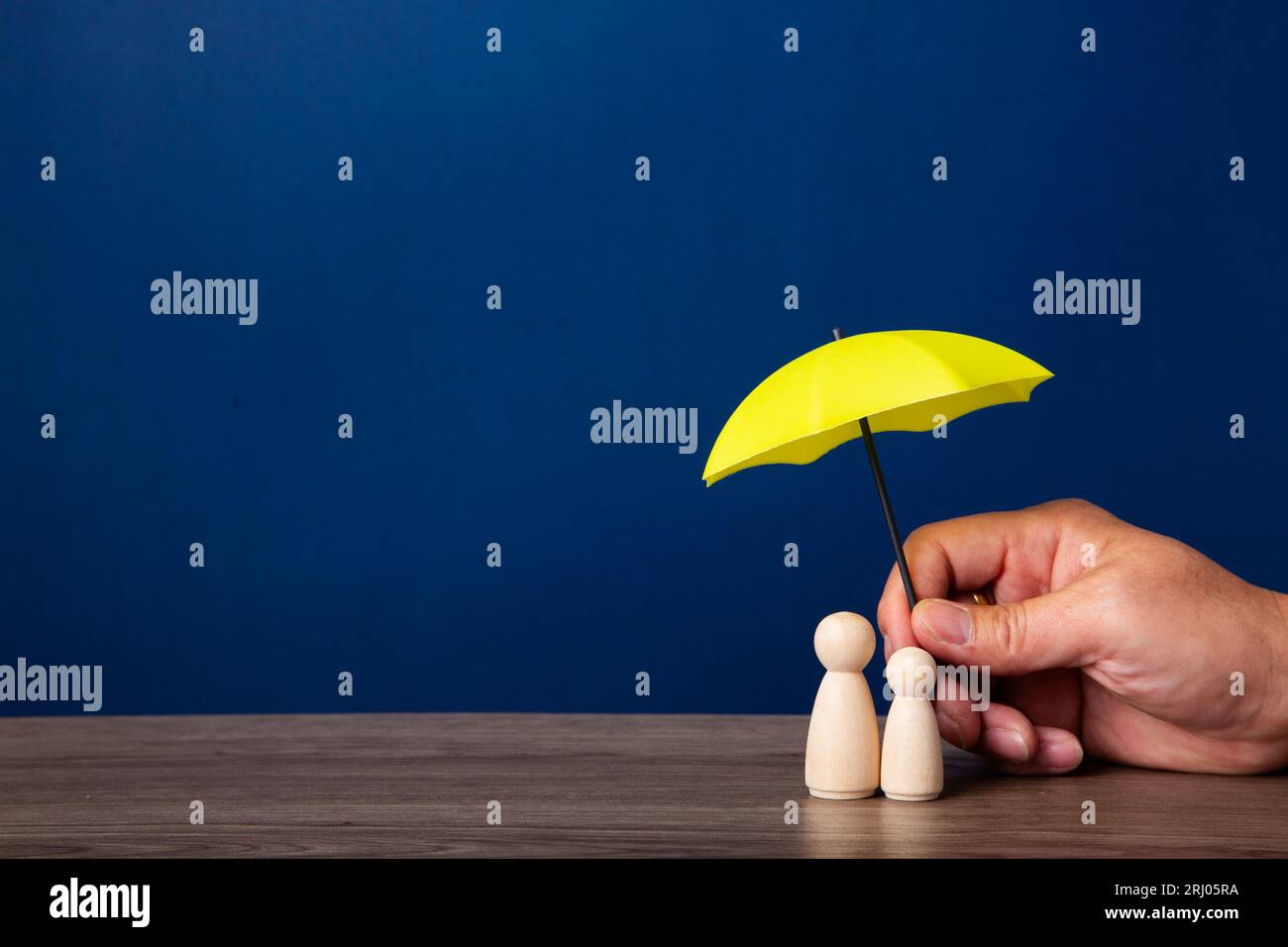 Hand holding umbrella family hi-res stock photography and images - Alamy