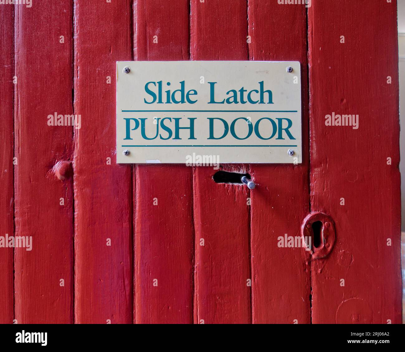 Slide latch, push door, sign for idiots on a door Stock Photo - Alamy