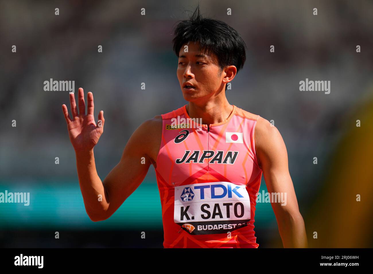 Kentaro Sato, of Japan waves after finishing a men's 400-meters heat during the World Athletics ...