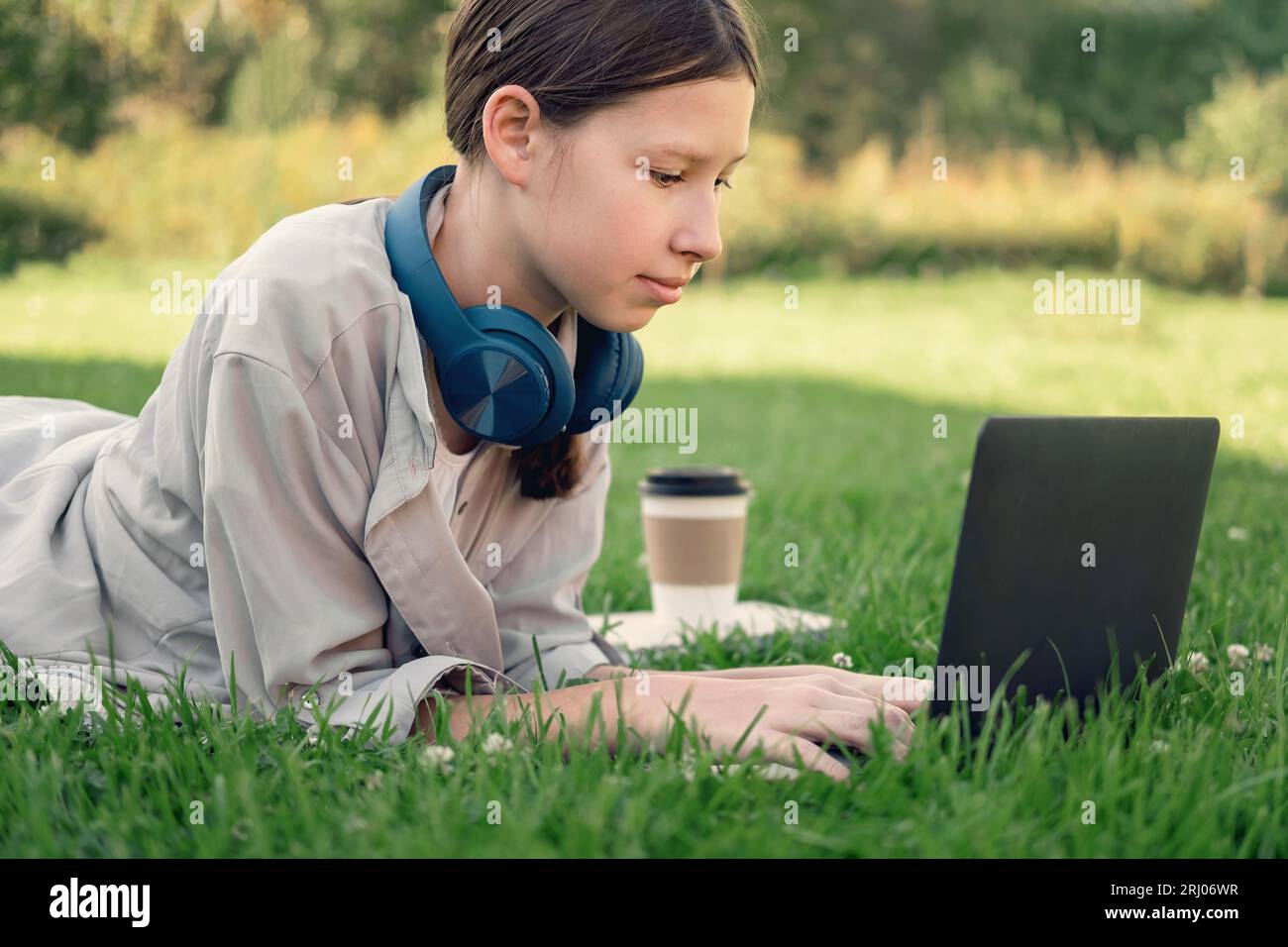 Teenage schoolgirl studying reading her books, tablet and notebook ...