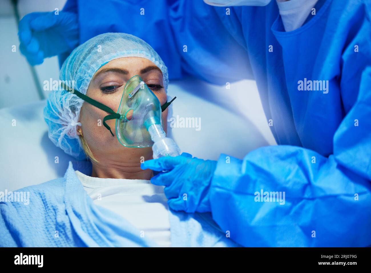 Surgery, anesthesia and doctor with woman with oxygen mask for medical ...