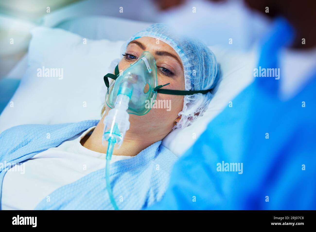 Hospital, anesthesia and woman with oxygen mask in surgery for medical ...