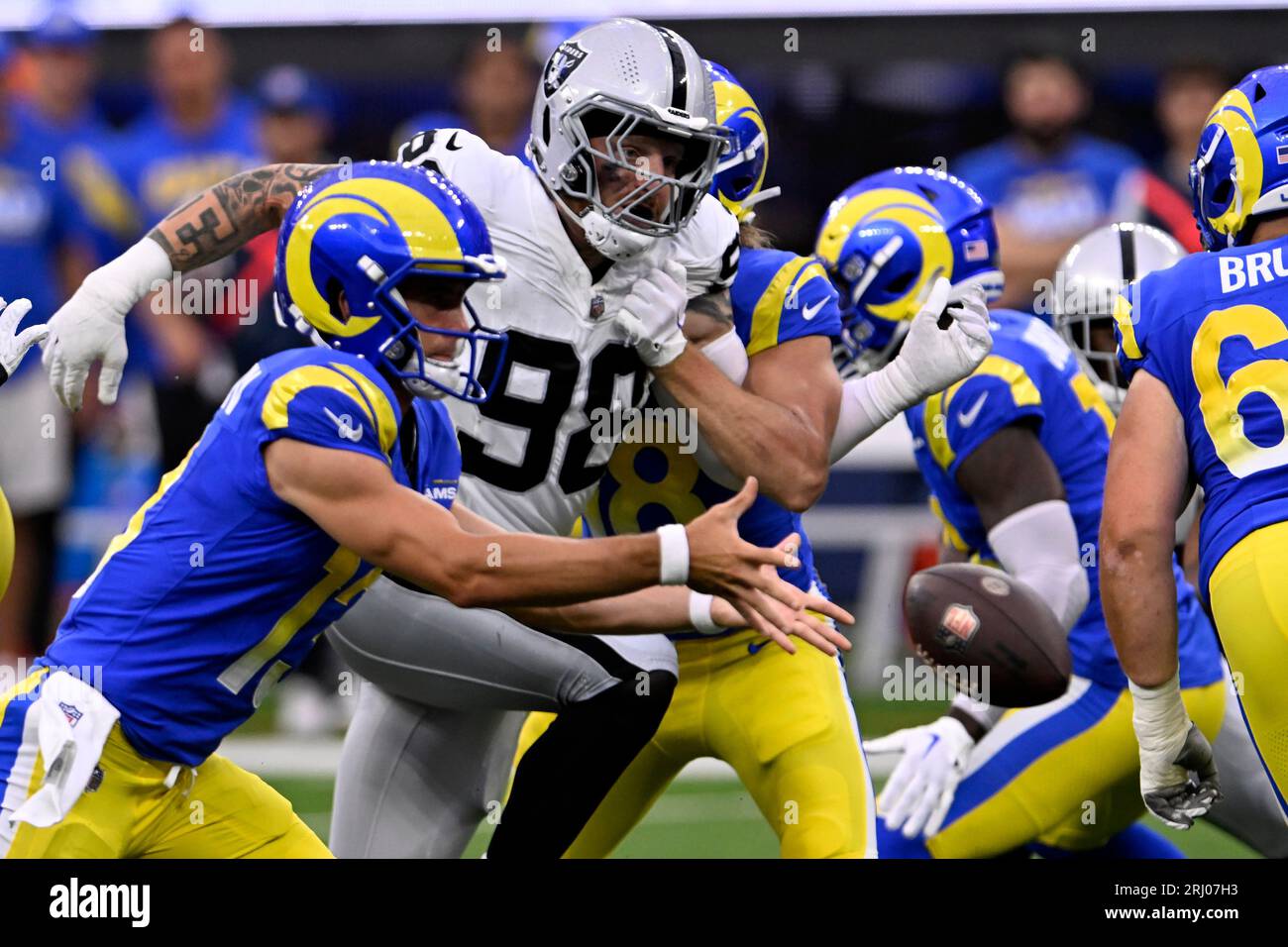 Las Vegas Raiders defensive end Maxx Crosby, center, gets blocked by ...