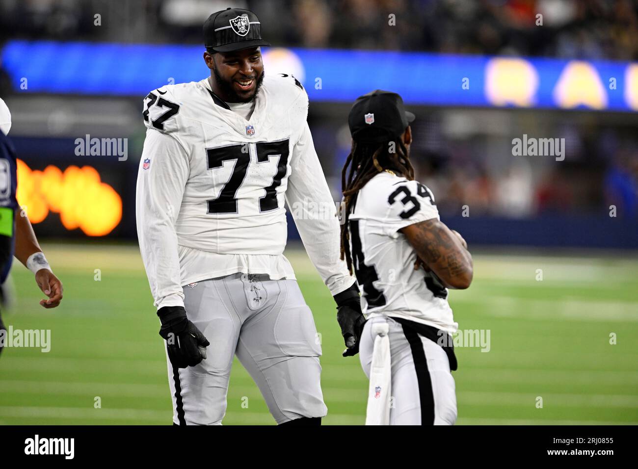 Las Vegas Raiders offensive tackle Thayer Munford Jr. (77) talks with ...