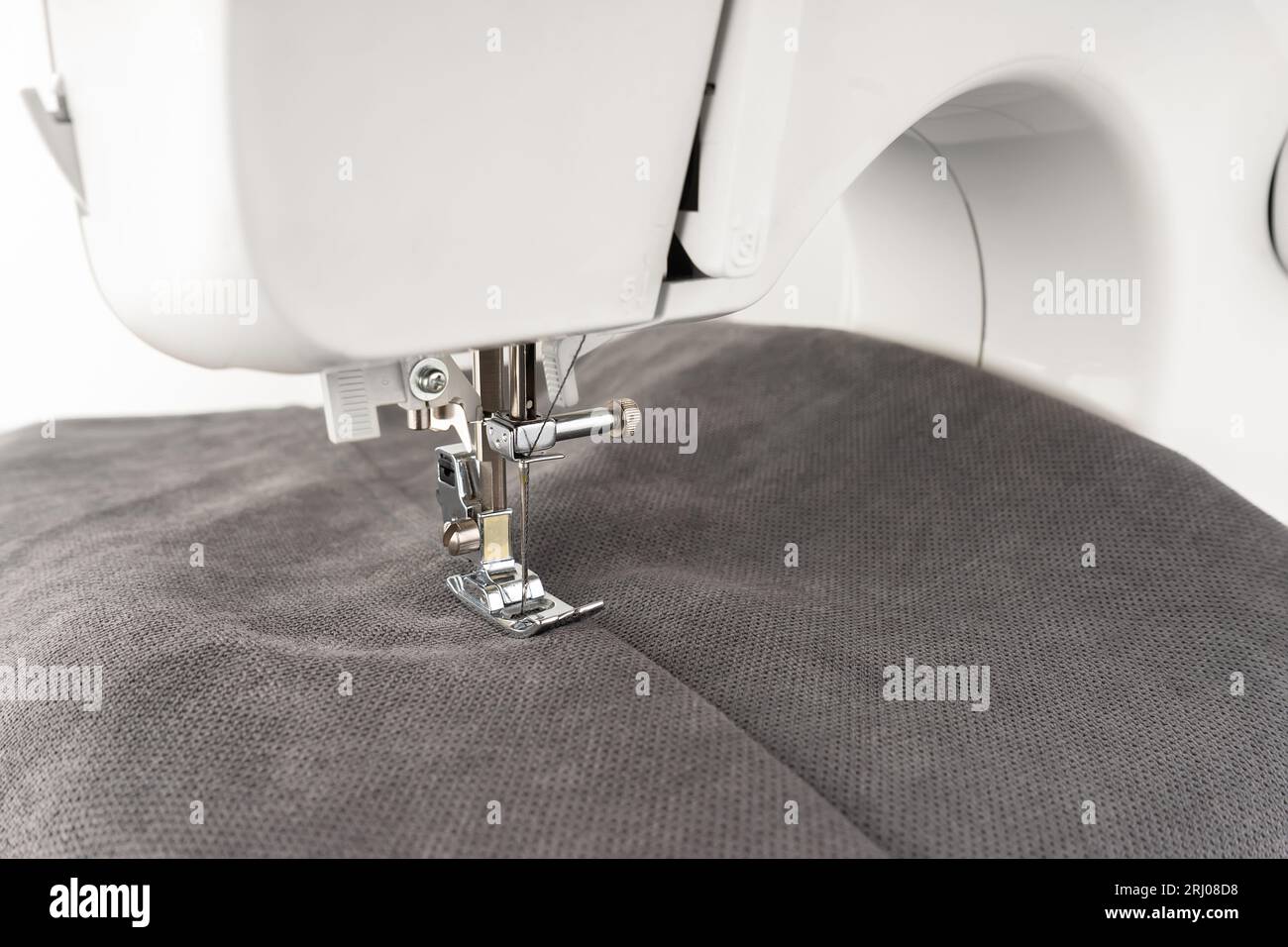 Modern sewing machine with gray fabric and. Sewing process clothes ...
