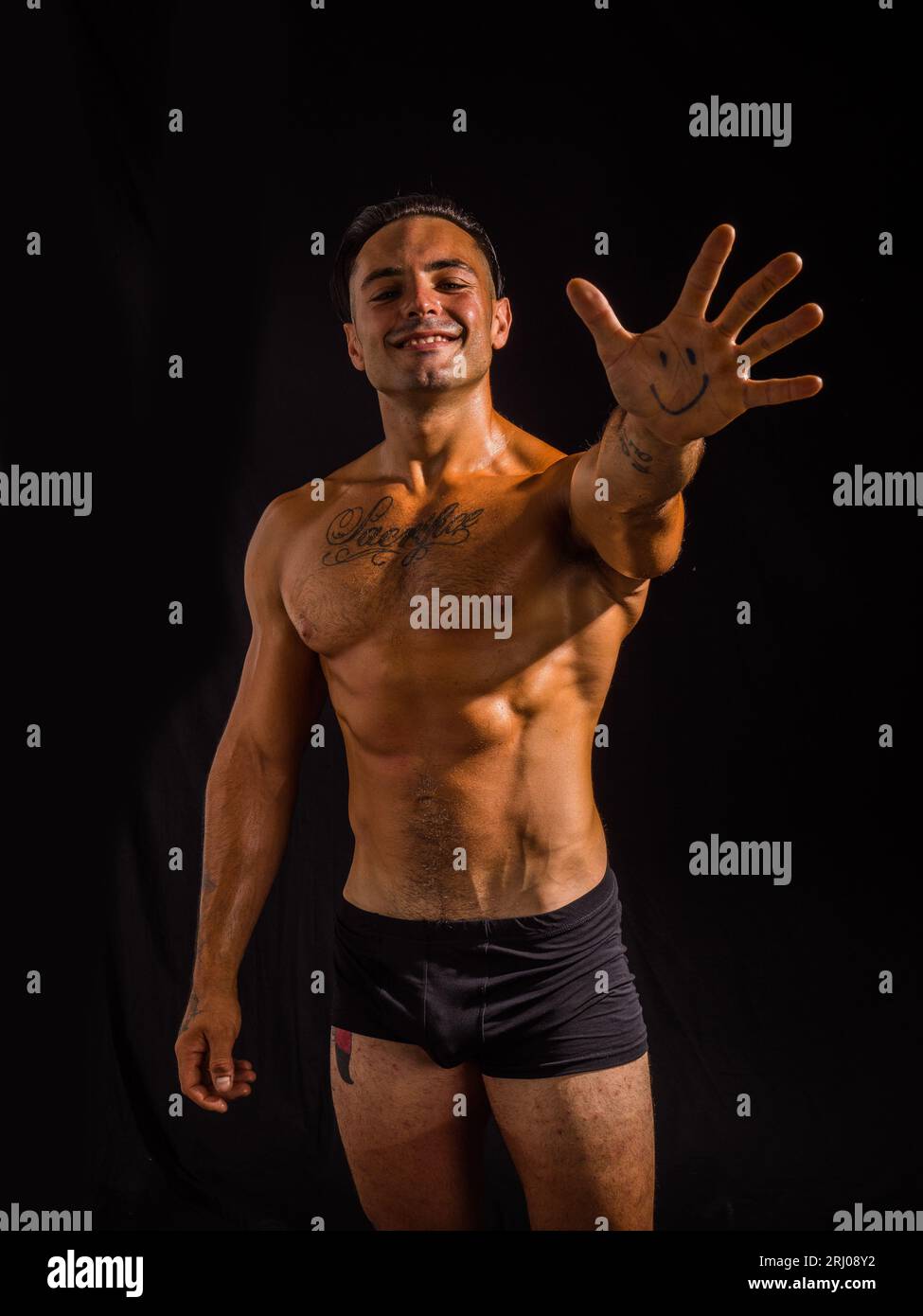 Photo of a shirtless man raising his hand up Stock Photo - Alamy