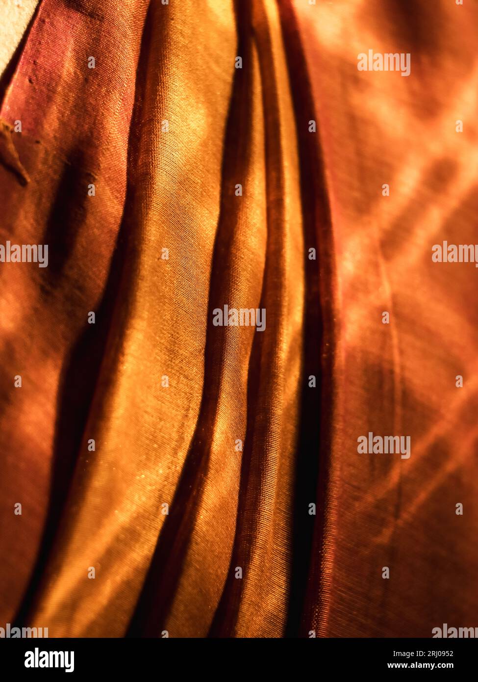 closeup of pleats of a traditional bright colored silk saree cloth ...