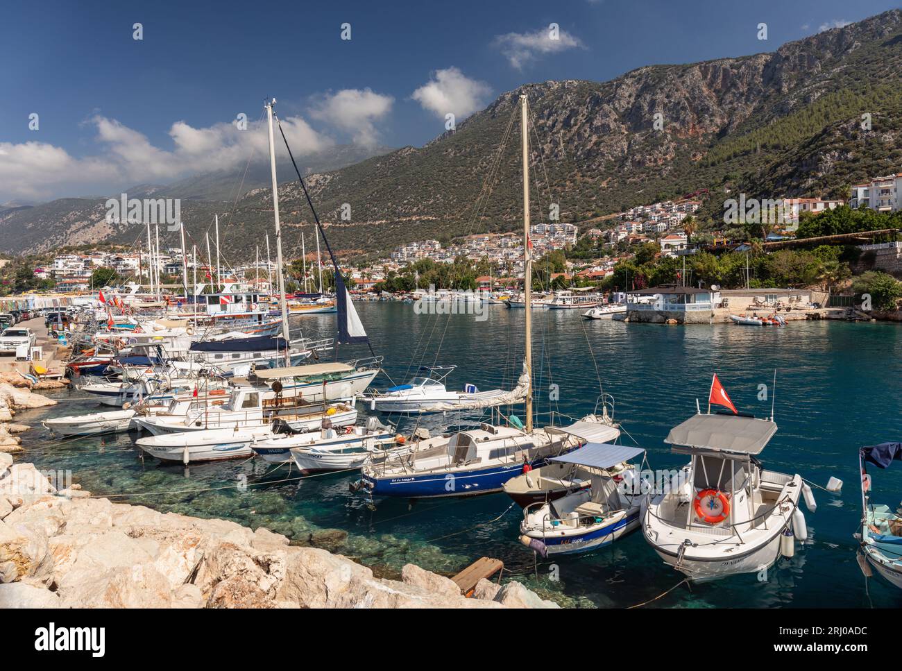 Kas harbour lined with boats and mountains in the background.. Kas is a ...
