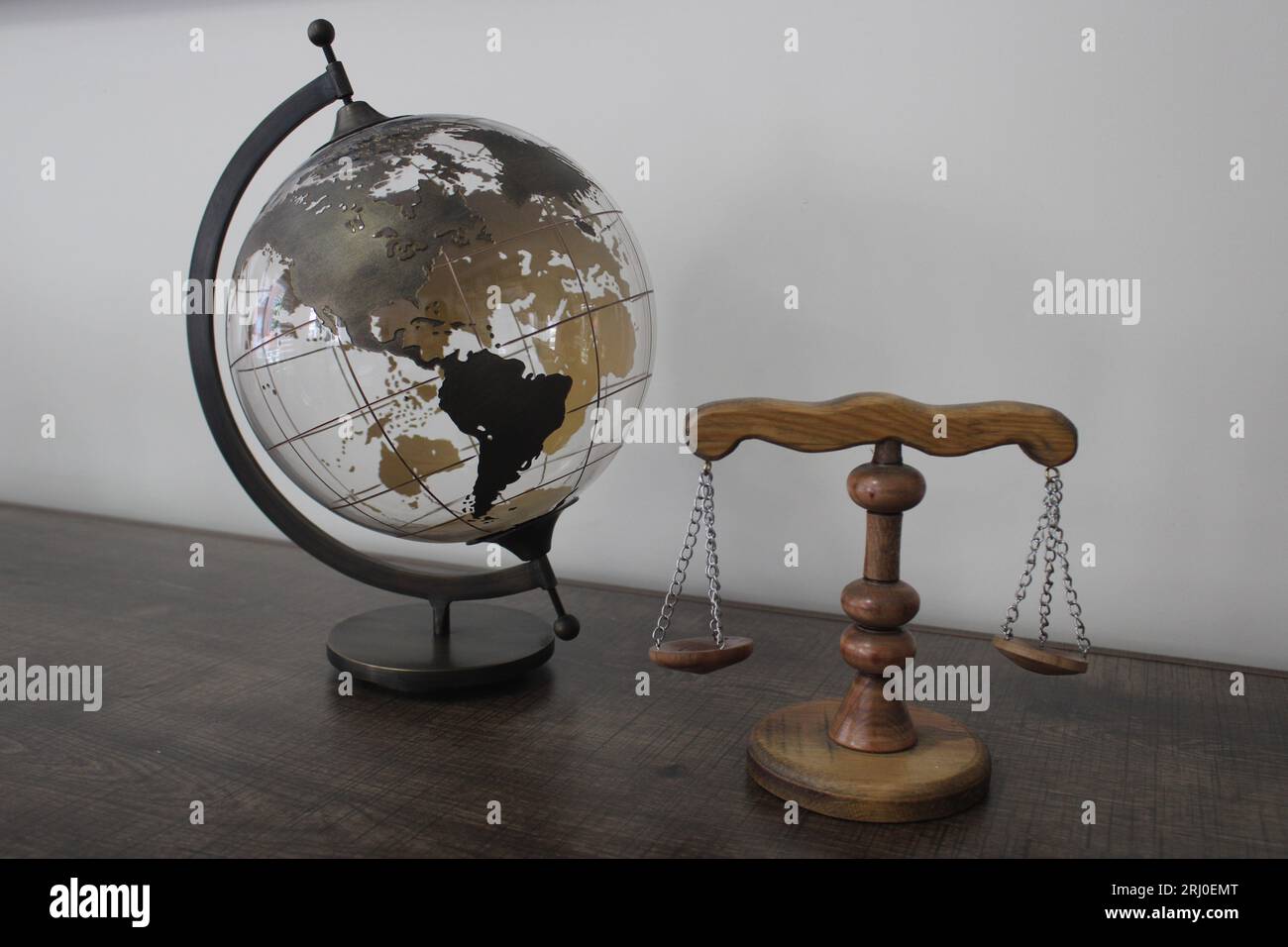 transparent world globe map and wooden scales of justice. lawyer scales ...