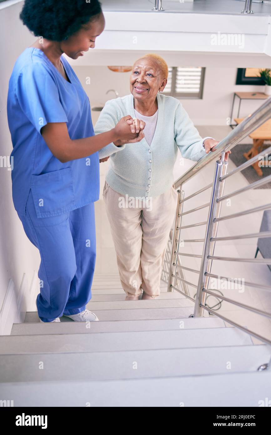 Caregiver, stairs and elderly woman holding hands, help and assistance ...