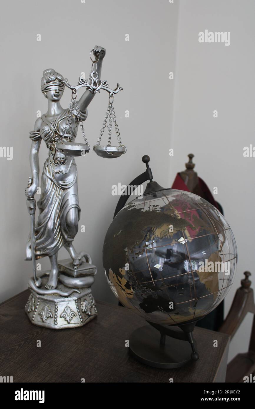 transparent world globe map and Statue of a woman symbolizing justice ...