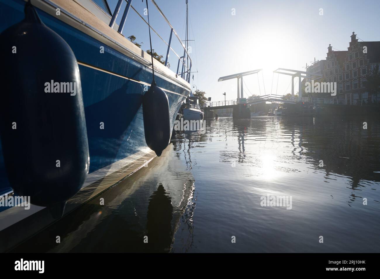 A yacht docked along the riverside in the city centre of Haarlem in ...
