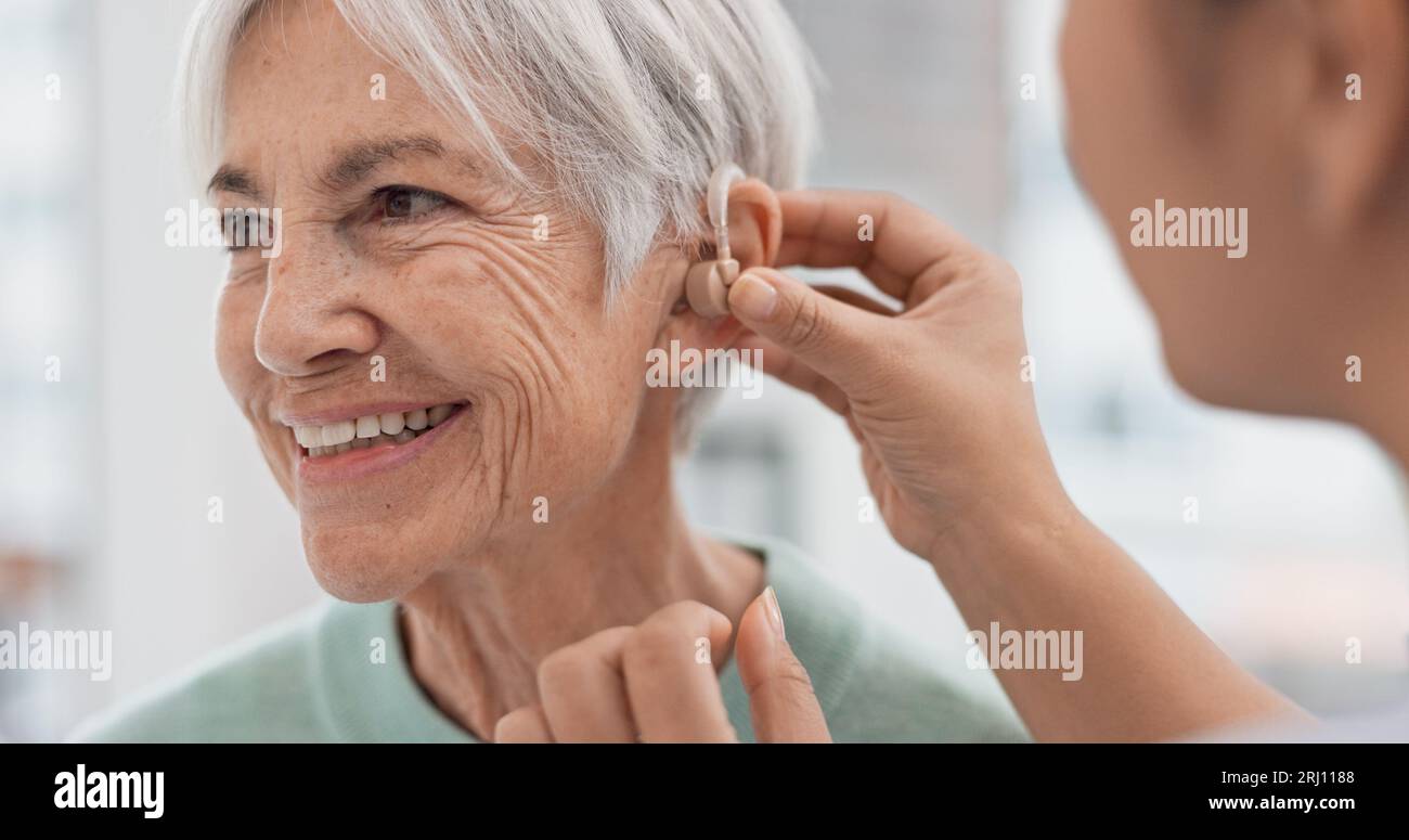 Old woman, doctor hands and patient with hearing aid, help and support ...