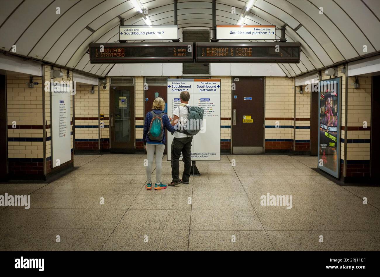 tourists looking at their route of tube and underground stations on the ...