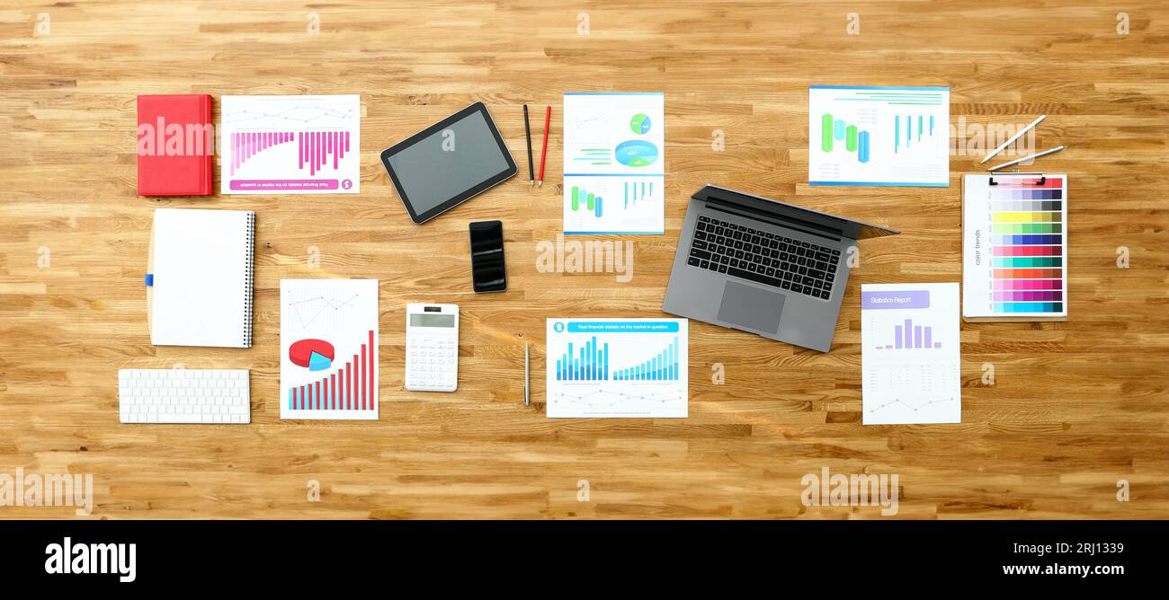 Paper with business chart on wooden office table Stock Photo - Alamy