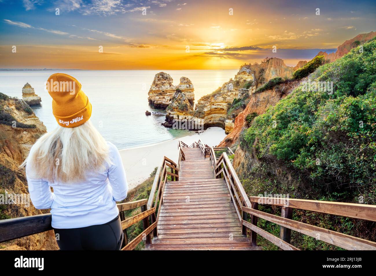Woman Traveler with stay Wild Beany enjoying the sunrise Boardwalk and ...