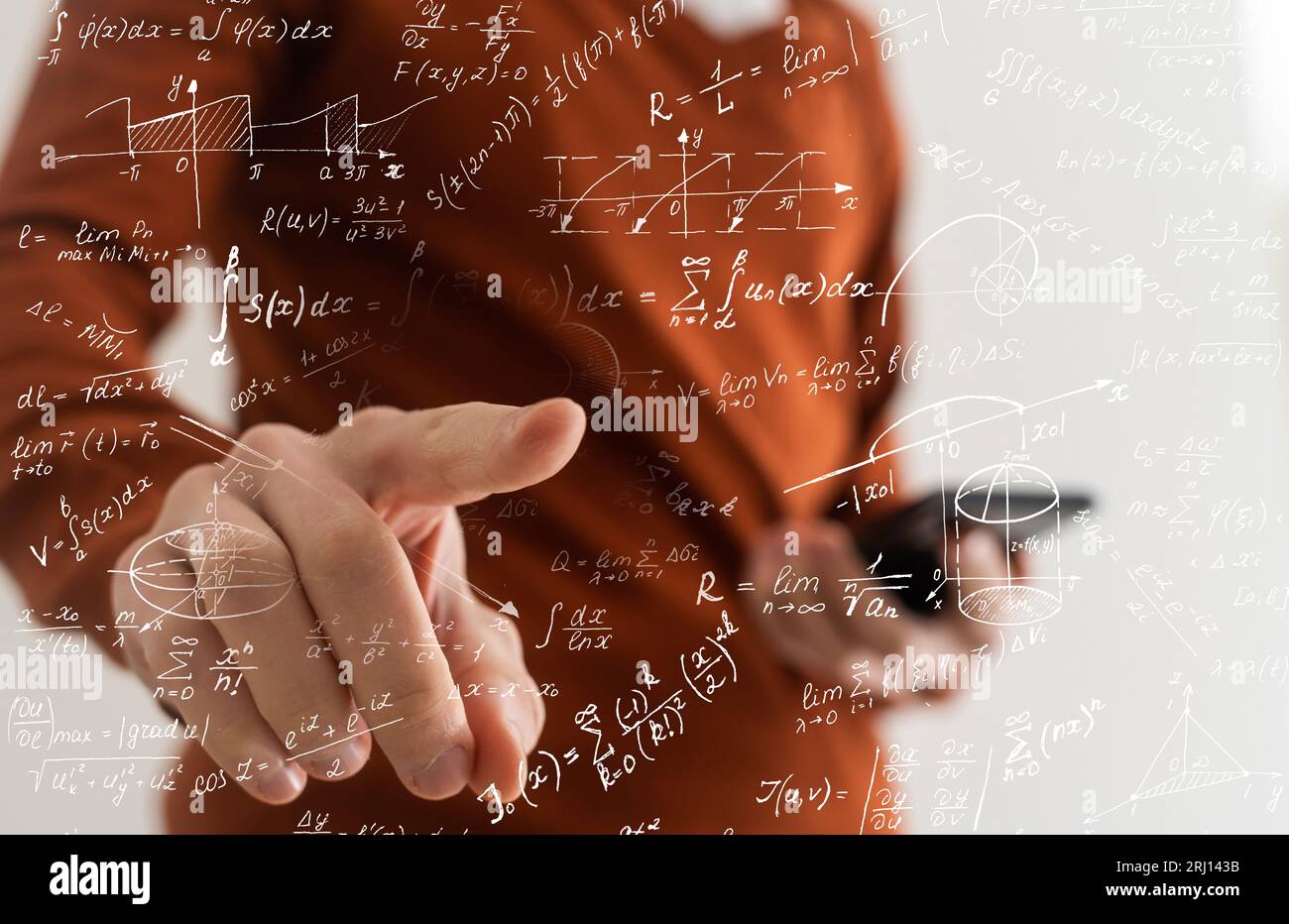 male teacher writing various high school maths and science formula on ...