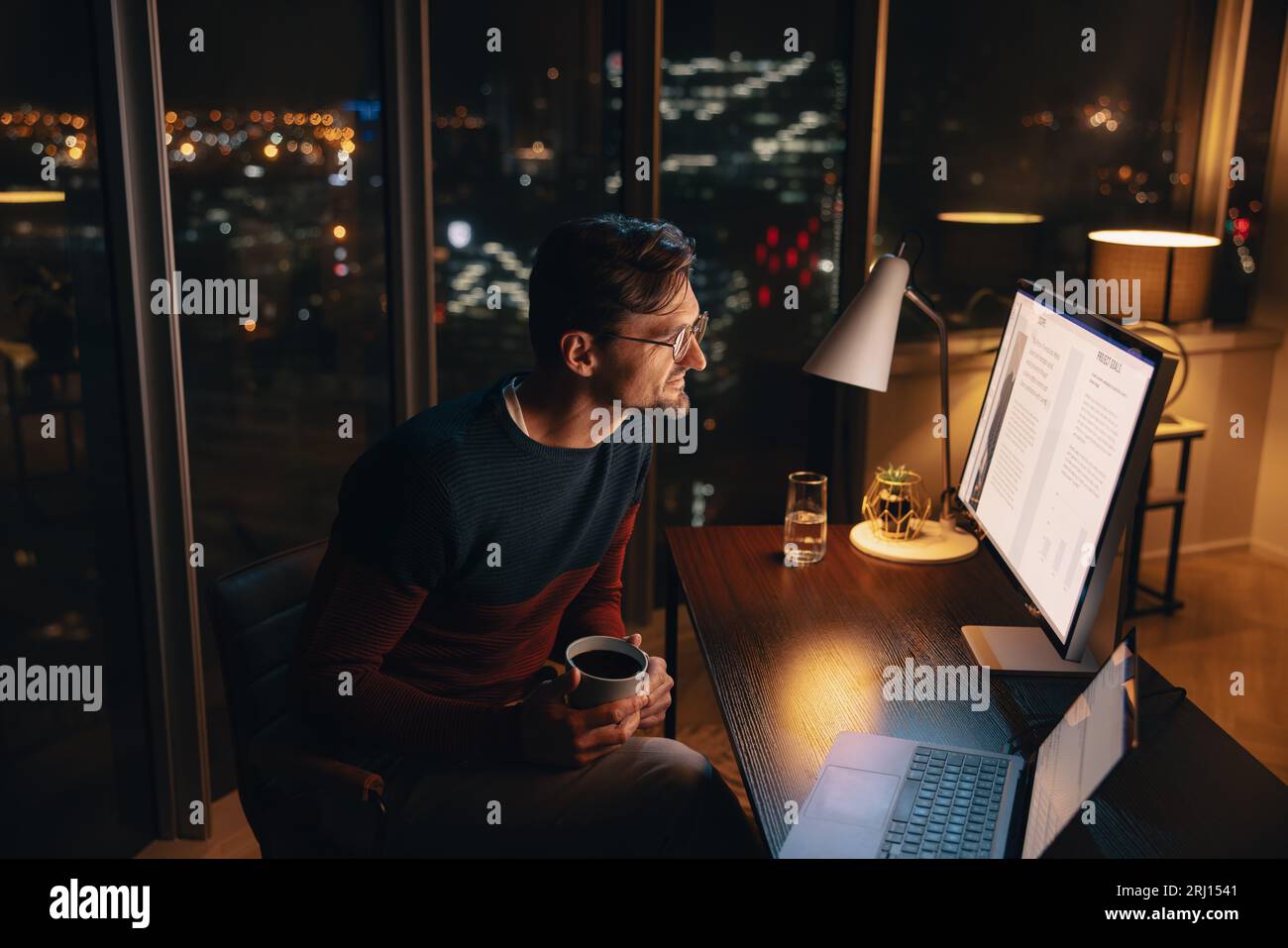 businessman works late at his home office, planning and managing a ...