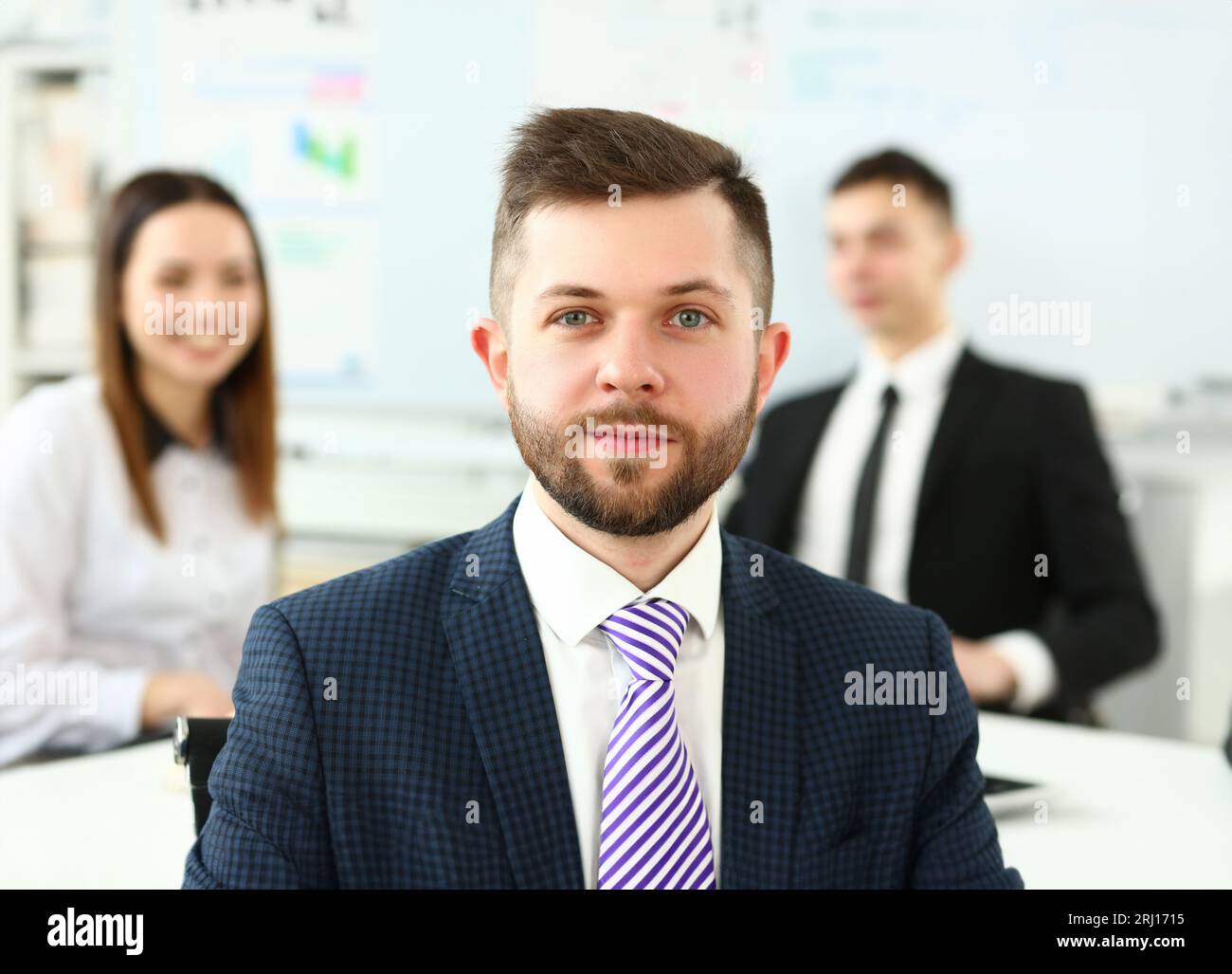 Cheerful clerk worker wearing suit and tie looking in camera in office ...