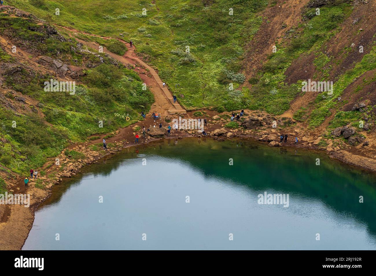 People exploring Kerid, volcanic crate lake in ,Grimsnes , Iceland ...
