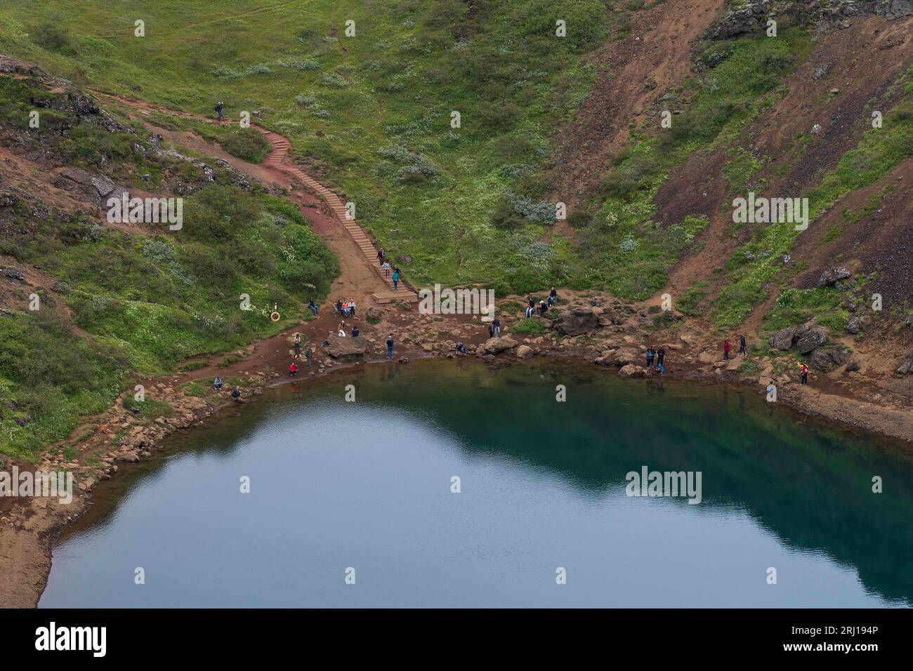 People exploring Kerid, volcanic crate lake in ,Grimsnes , Iceland ...