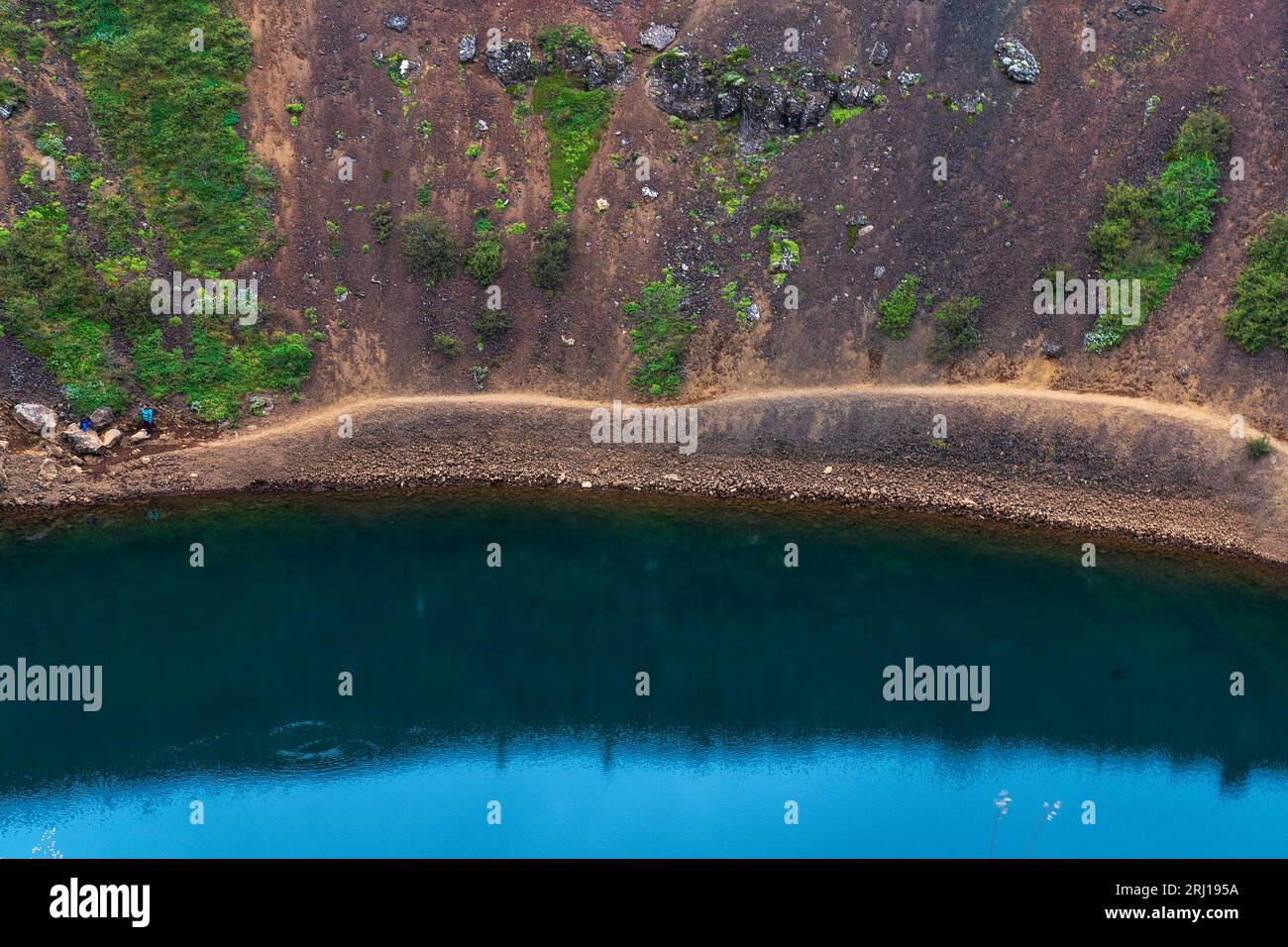 People exploring Kerid, volcanic crate lake in ,Grimsnes , Iceland ...