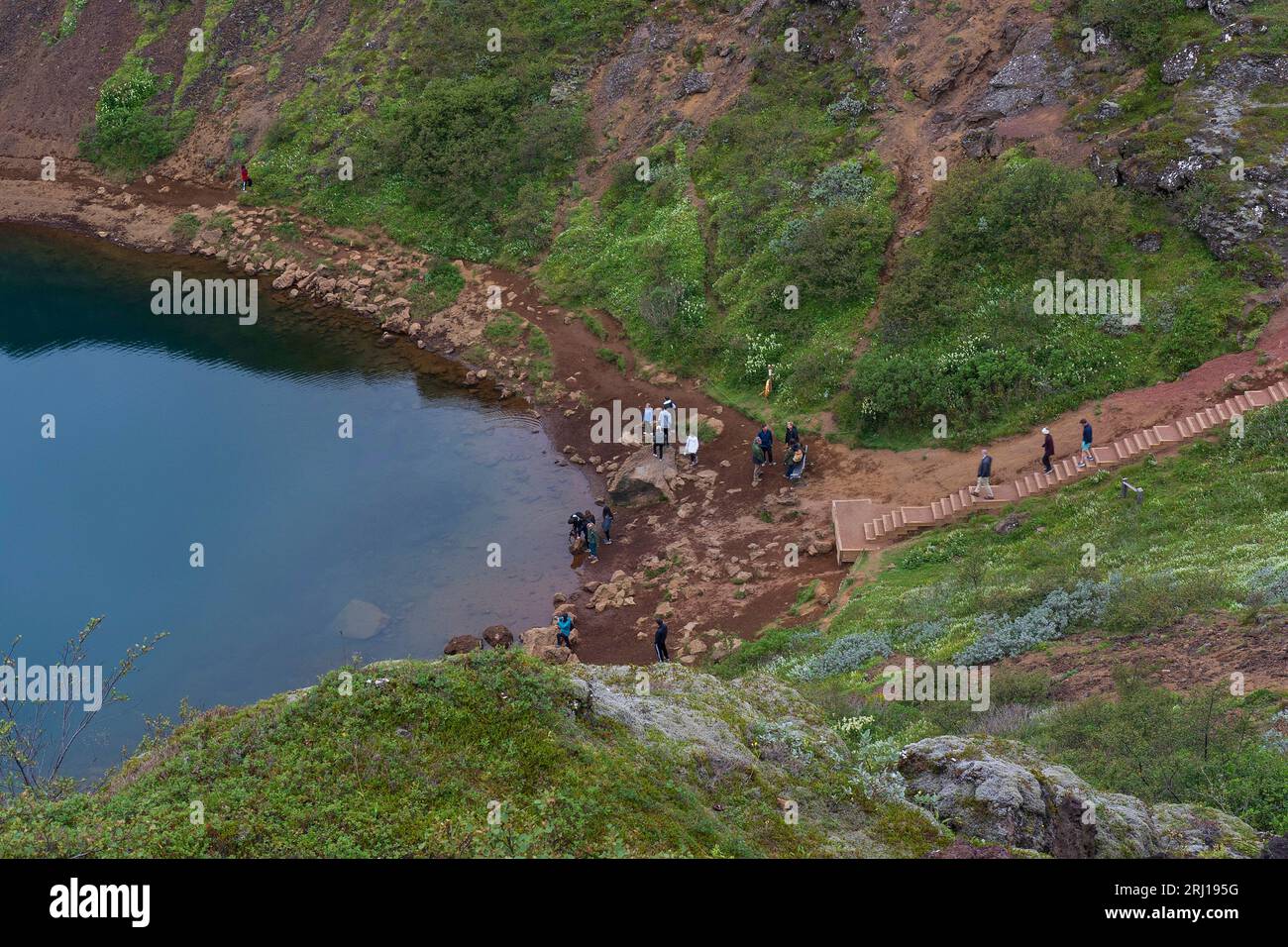 People exploring Kerid, volcanic crate lake in ,Grimsnes , Iceland ...