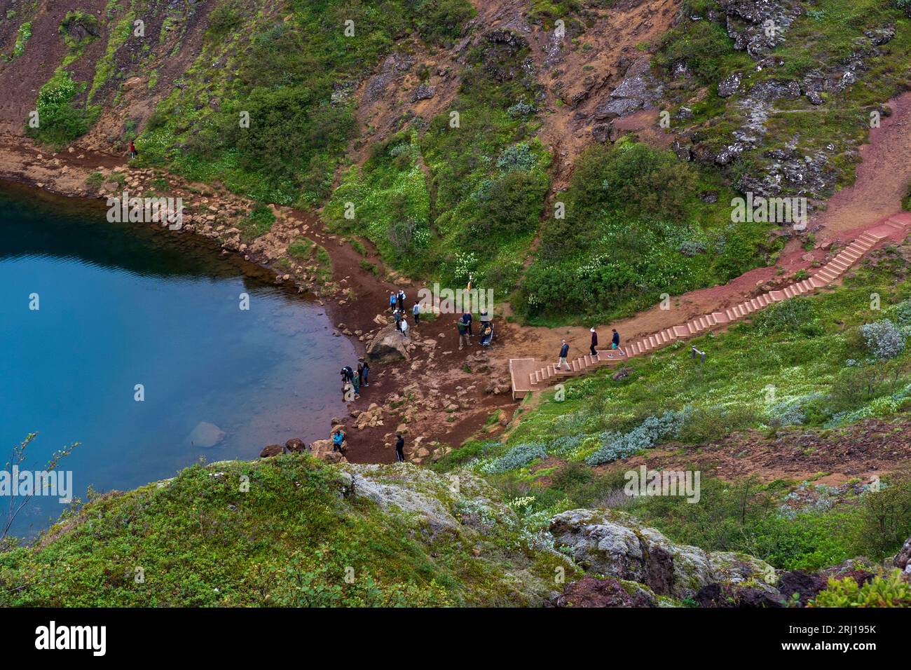 People exploring Kerid, volcanic crate lake in ,Grimsnes , Iceland ...