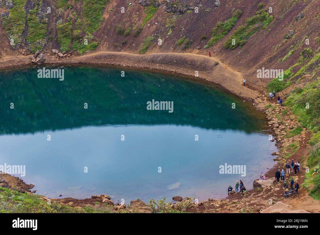 People exploring Kerid, volcanic crate lake in ,Grimsnes , Iceland ...
