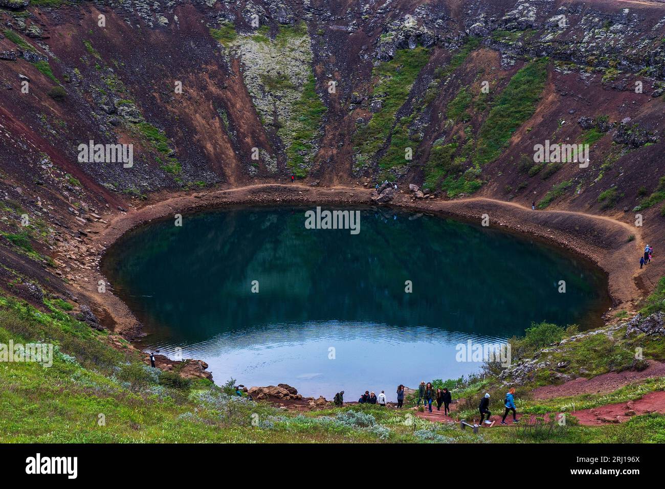 People exploring Kerid, volcanic crate lake in ,Grimsnes , Iceland ...