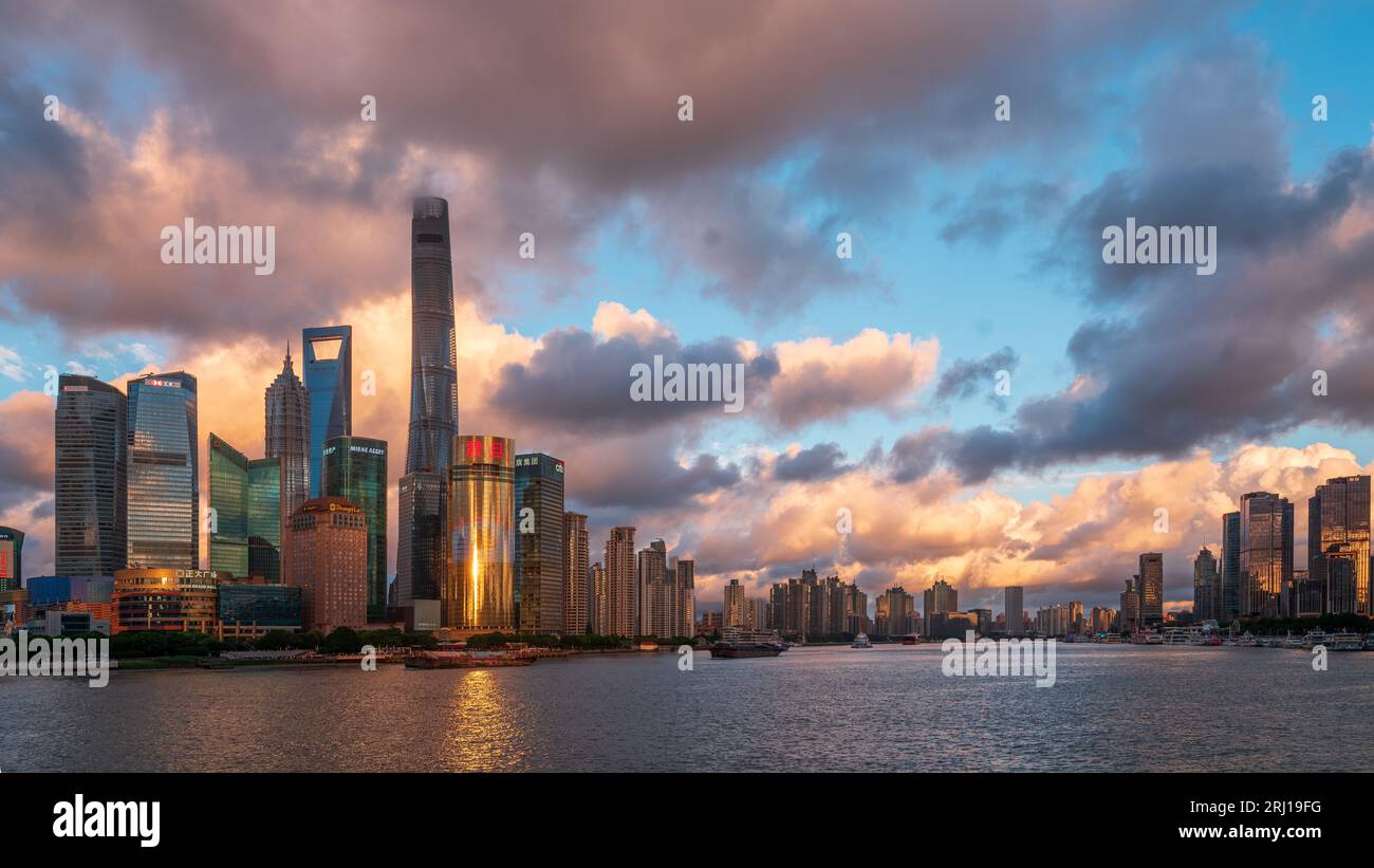 Opposite the direction of sunset, the skyscrapers under the cloud are ...