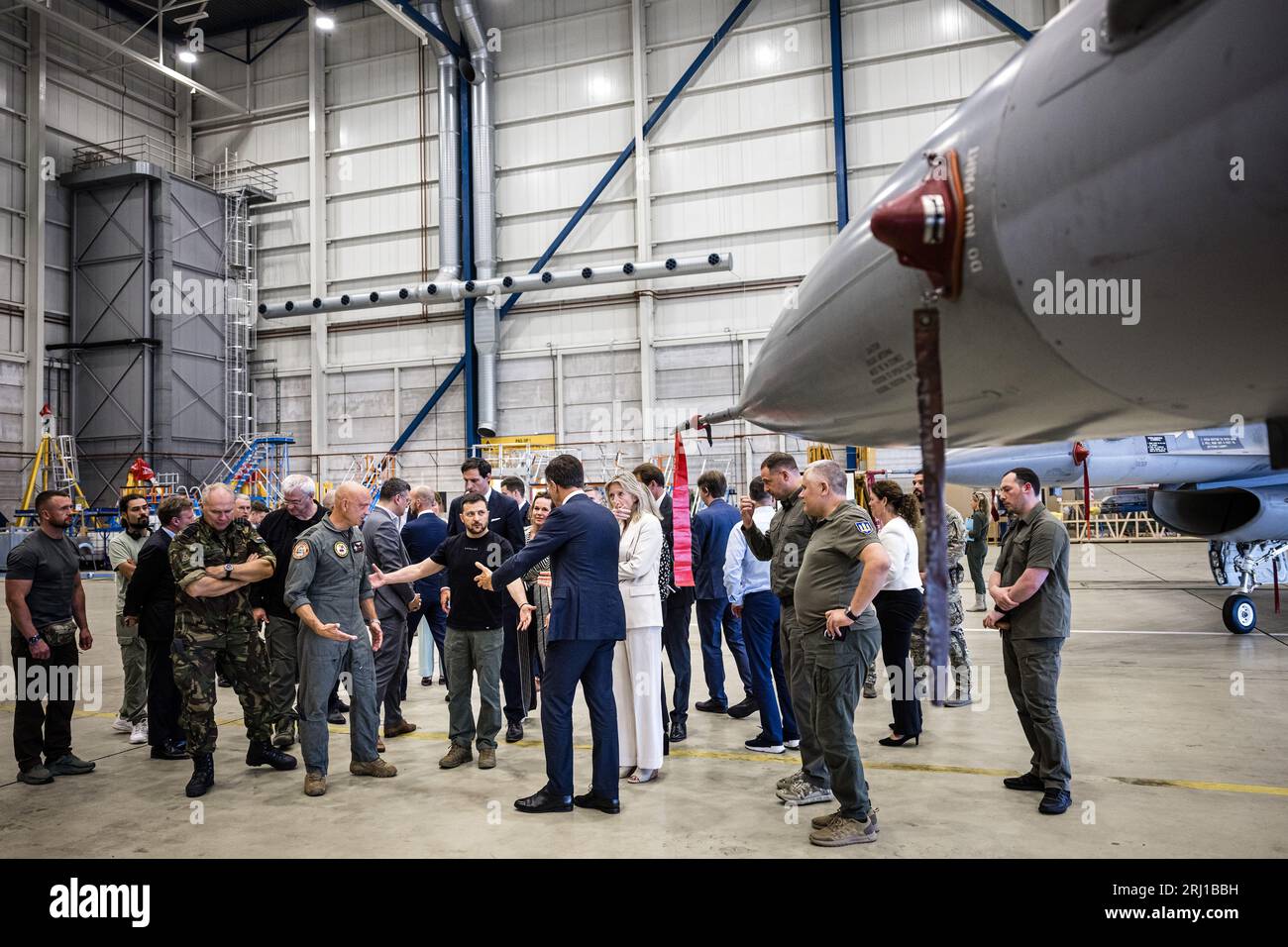 Ukrainian president Volodymyr Zelensky looks at the F16s in a hangar ...