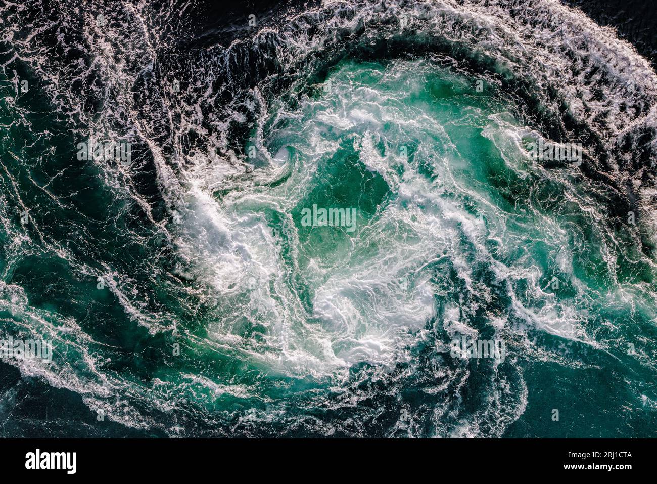 Blue waves of water of the river and the sea meet each other during ...