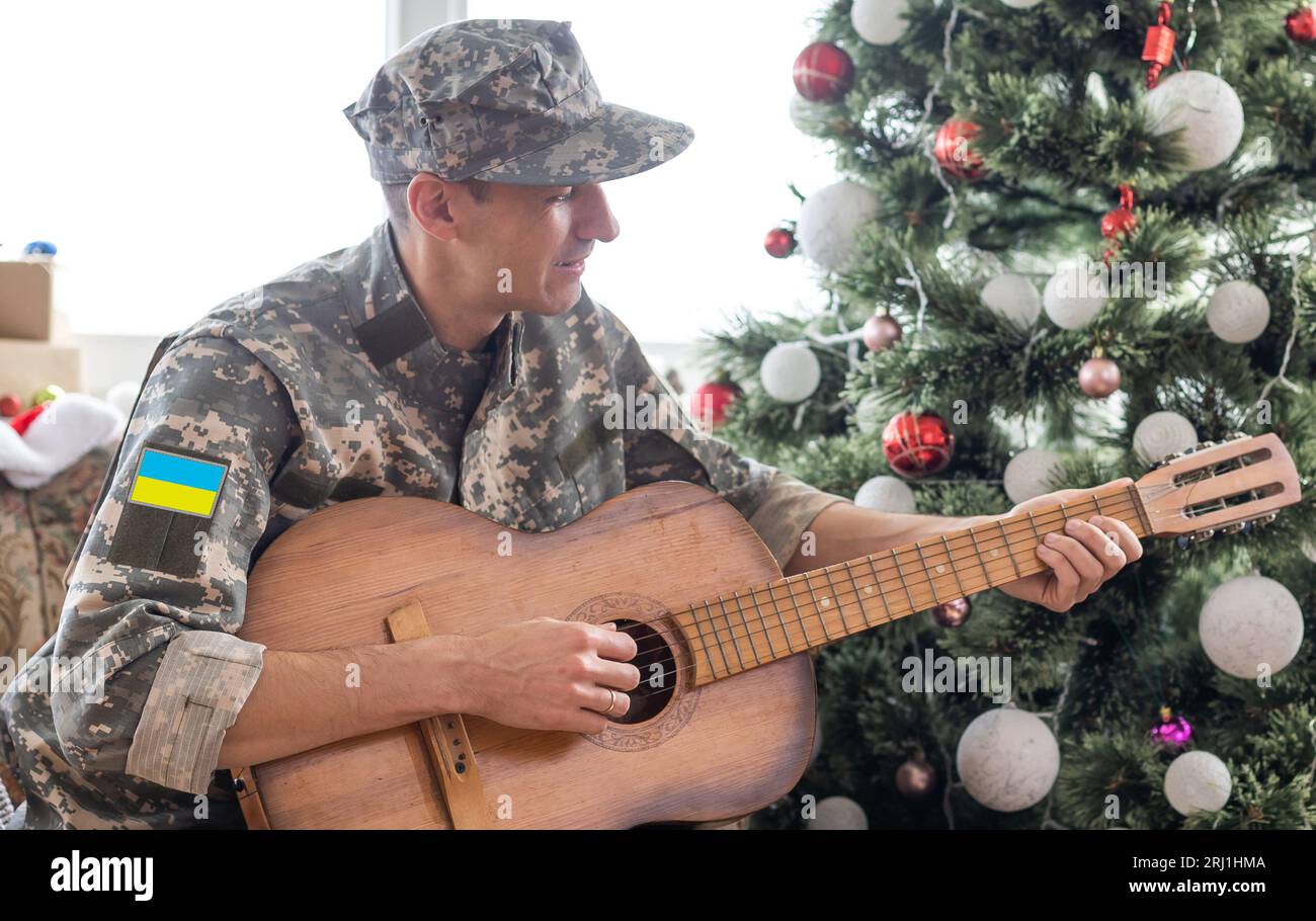 Ukrainian military man with a guitar Stock Photo - Alamy