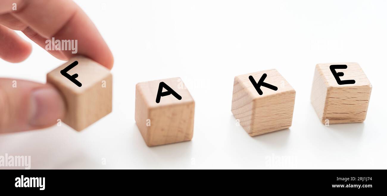 Hand putting wooden cubes for change wording from fake to fact Stock ...