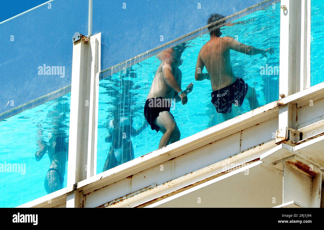 Tourists in Mallorca, enjoying a swim in an elevated pool in the ...