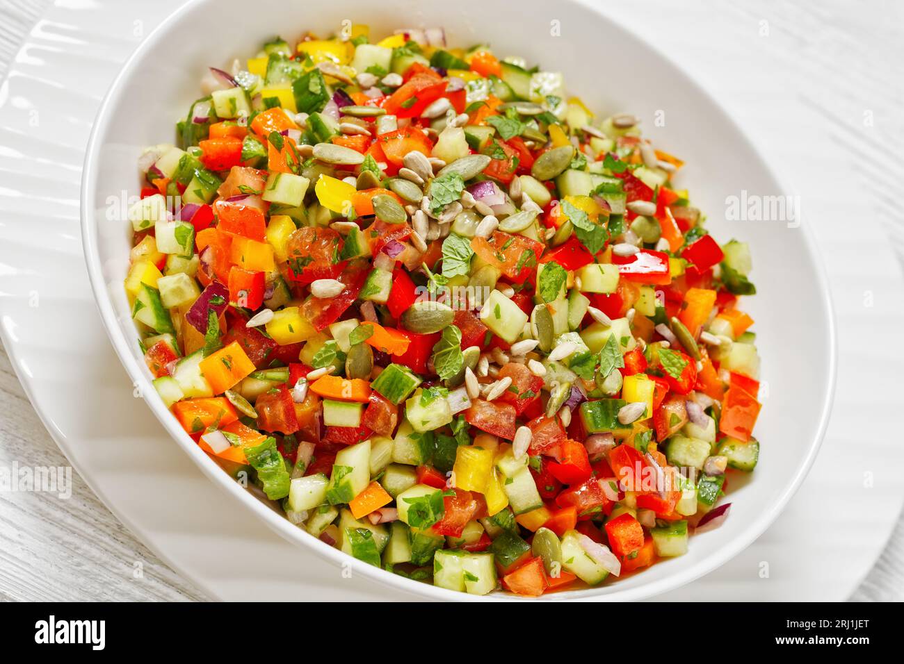 Israeli salad of finely diced tomato, onion, cucumber, and bell peppers ...